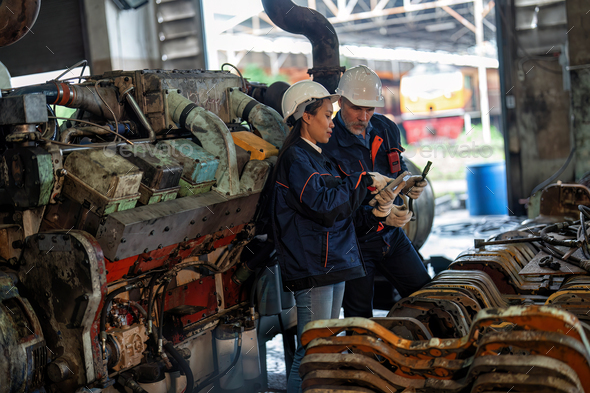 Maintenance manager and engineer checking part large engine ...