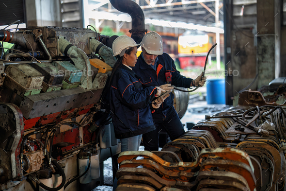 Maintenance manager and engineer checking part large engine ...
