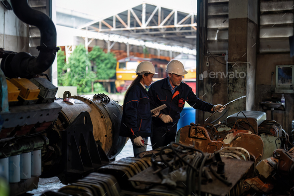Maintenance manager and engineer checking part large engine ...