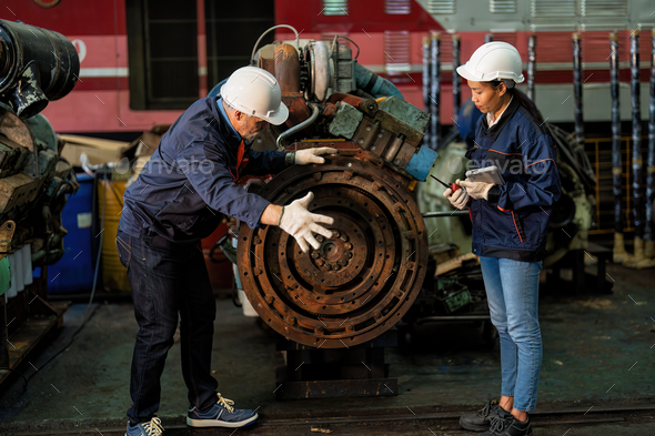 Maintenance manager and engineer checking part large engine ...
