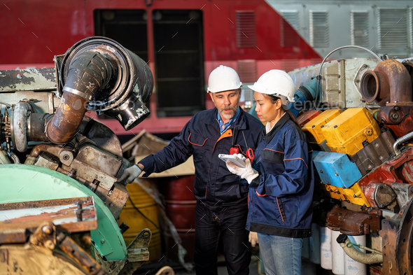Maintenance manager and engineer checking part large engine ...