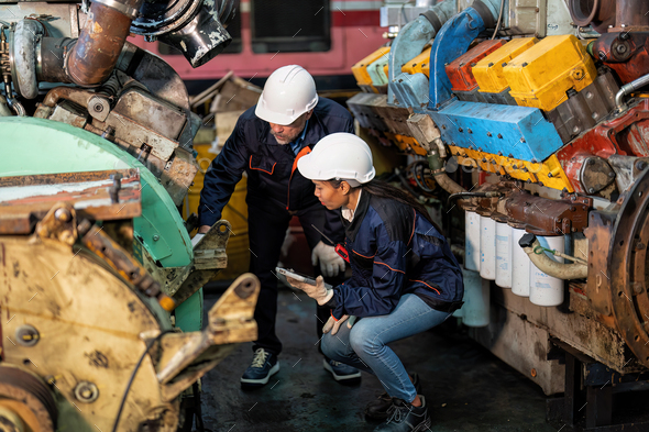 Maintenance manager and engineer checking part large engine ...