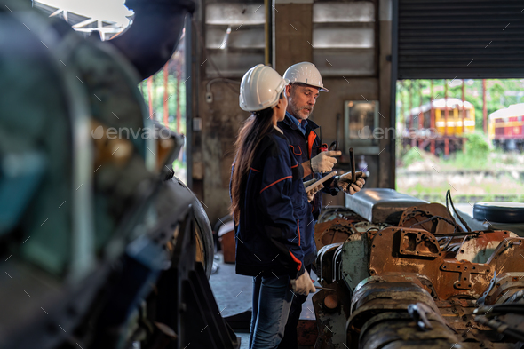Maintenance manager and engineer checking part large engine ...