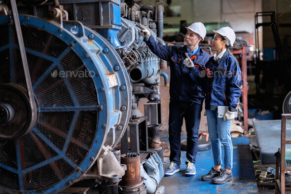 Maintenance manager and engineer checking part large engine ...