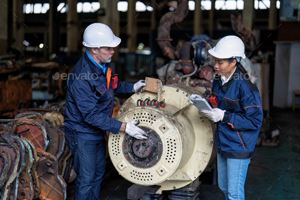 Maintenance manager and engineer checking part large engine ...