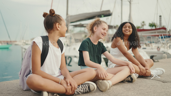 Teenagers singing and clapping on the outdoors in seascape background ...