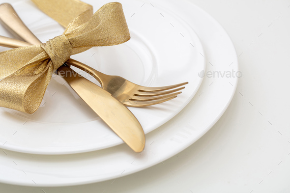 Christmas table setting close up. Gold cutlery and decoration on white ...