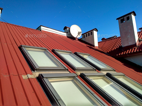 Red tiled house roof with attic windows. Roofing construction, window ...