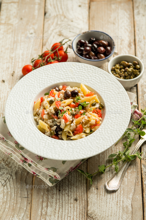 pasta with fish ragout black olives and capers Stock Photo by MarcoMayer