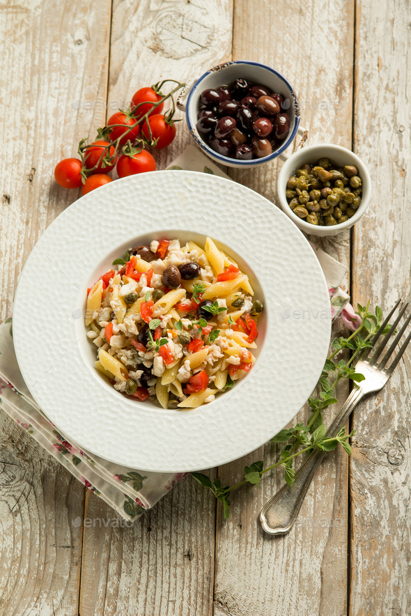 pasta with fish ragout black olives and capers Stock Photo by MarcoMayer