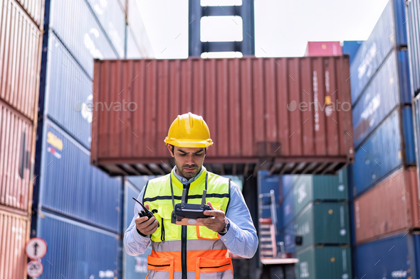 Engineer working in container storage yard fly drone looking location ...