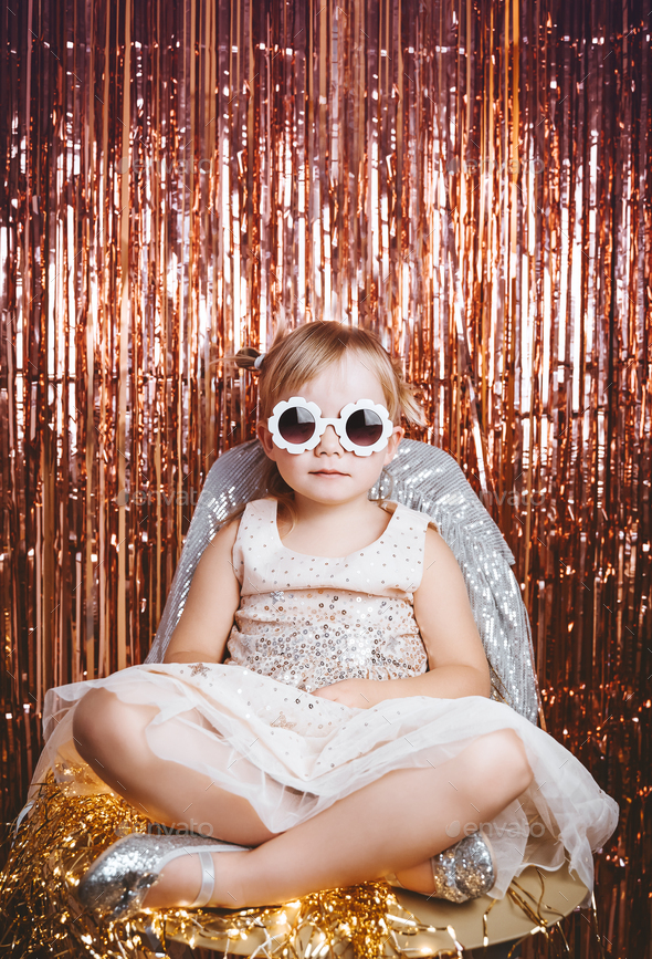 Happy little stylish girl in shiny dress having fun. Stock Photo by ...