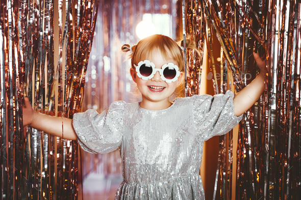 Happy little stylish girl in shiny dress having fun. Stock Photo by ...
