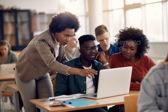 African Americans college students e-leaning with their teacher during ...