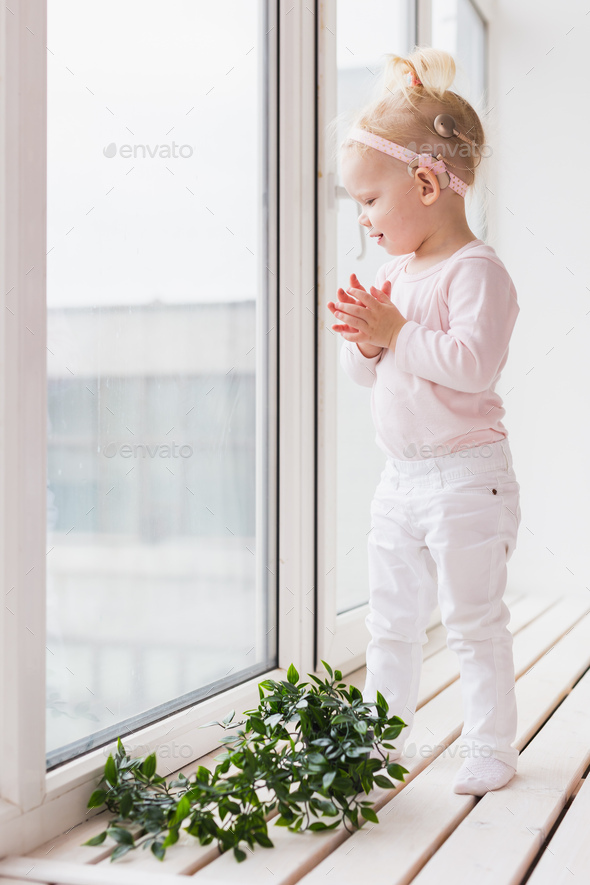 Cochlear implant for baby. Deaf child with hearing aid at home ...