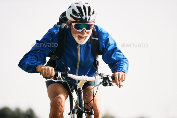 Active mature cyclist enjoying the ride in nature. Stock Photo by ...