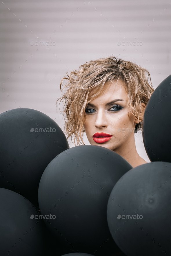Portrait beautiful woman of model appearance with dark balloons. Art ...