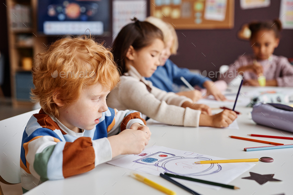 Row of diligent learners of nursery school with cute boy in front Stock ...