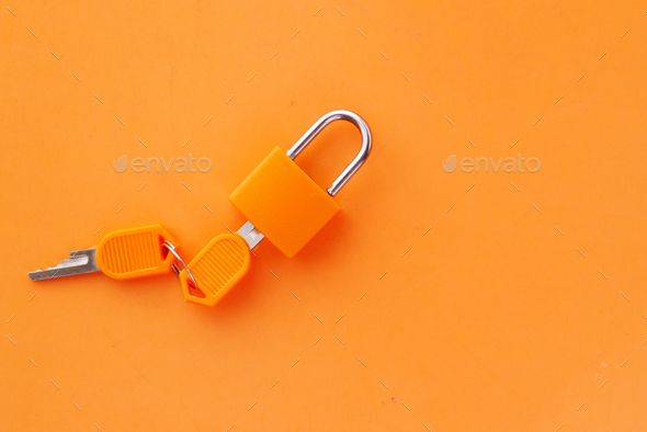 orange color Padlock And Key on table Stock Photo by towfiqu98 | PhotoDune