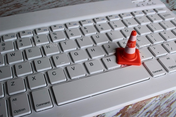 Safety cone and keyboard computer Stock Photo by mohdizzuanbinroslan