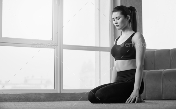 Slim young woman sitting on legs. Stock Photo by serhiibobyk | PhotoDune