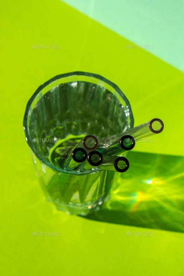 Reusable glass Straws in Glass with water on green background Eco ...