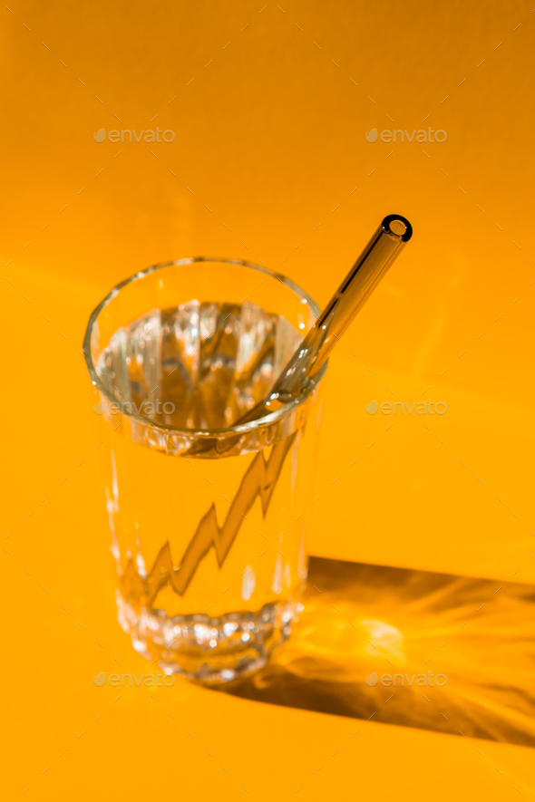 Reusable glass Straws in Glass with water on yellow background Eco ...