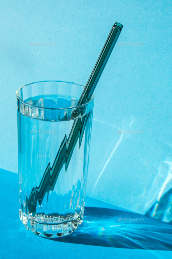 Reusable glass Straws in Glass with water on blue background Eco ...