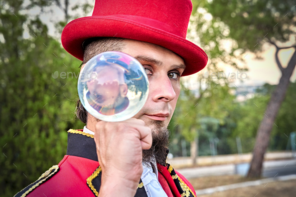 Male juggler balancing on a crystal ball Stock Photo by jmartinstock