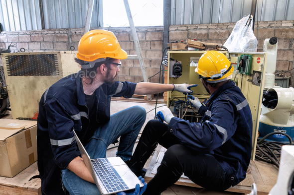 In robotic repair shop engineer troubleshoot repair electrical ...