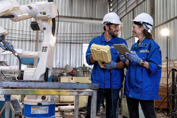 In robotic training center instructor use tablet pc teach girl engineer ...