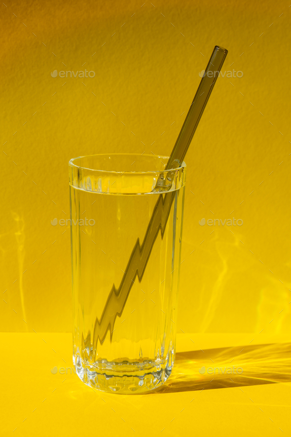 Reusable glass Straws in Glass with water on yellow background Eco ...