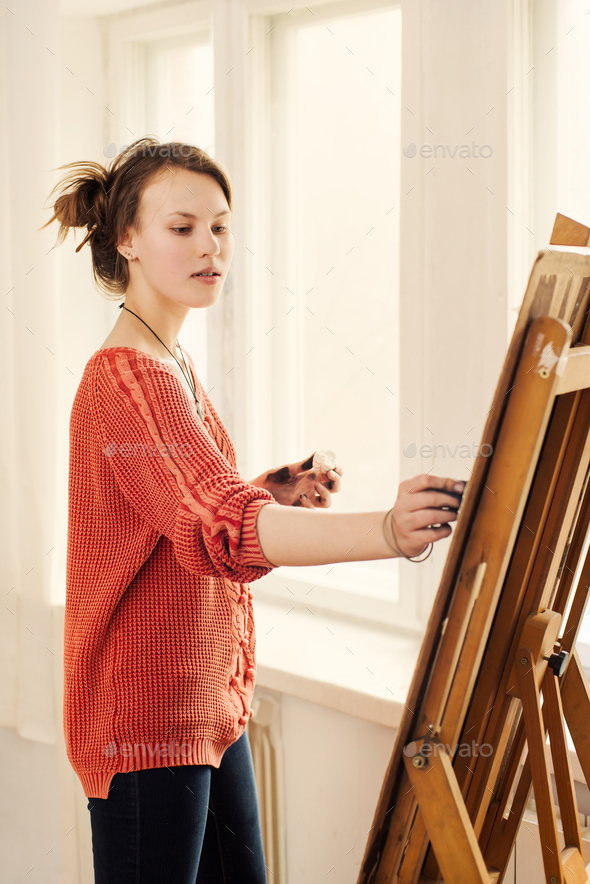 Beautiful woman artist drawing her picture Stock Photo by gilitukha