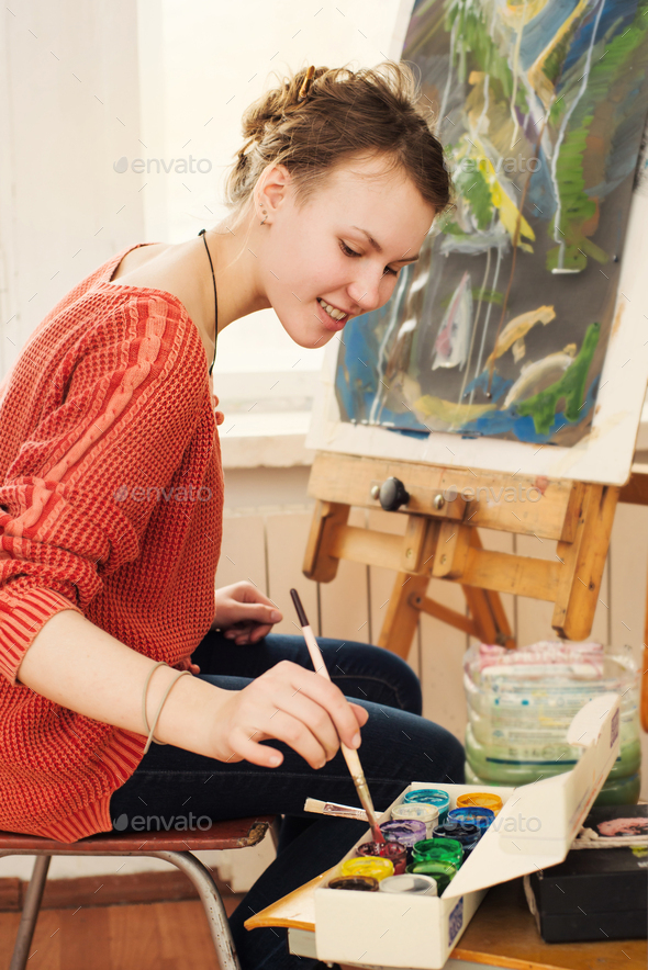 Beautiful woman artist drawing her picture Stock Photo by gilitukha