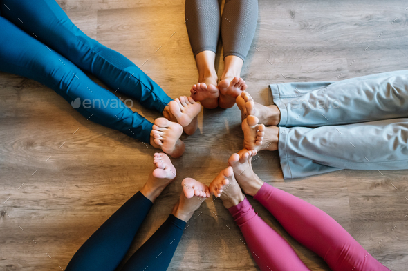 Barefoot people joining feet in circle Stock Photo by guillemd | PhotoDune