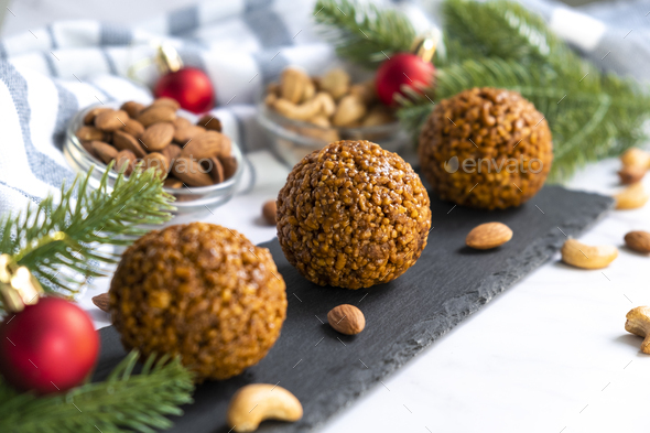 Christmas nut balls cookie on black slate board with almond and cashew ...