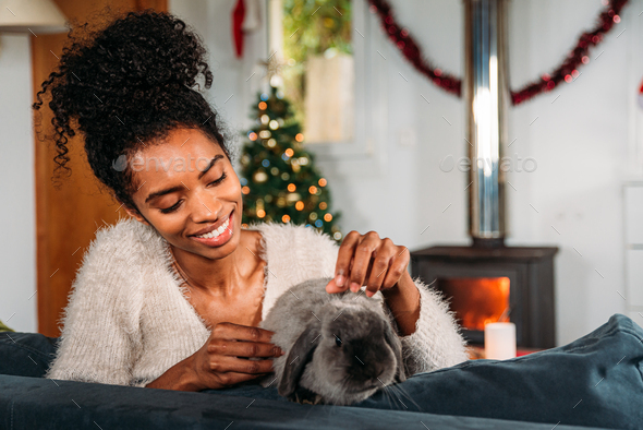 Black woman with rabbit on Christmas Stock Photo by davidpradoperucha
