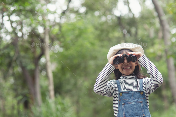 Happy kid looking ahead. Smiling child with the binoculars. Travel and ...