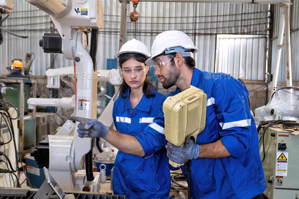 In robotic training center instructor teaching girl engineer how to ...