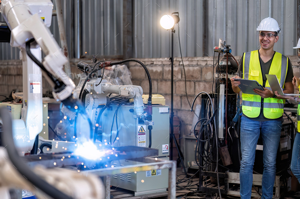 In robotic maintenance shop engineer busy commissioning and operate ...