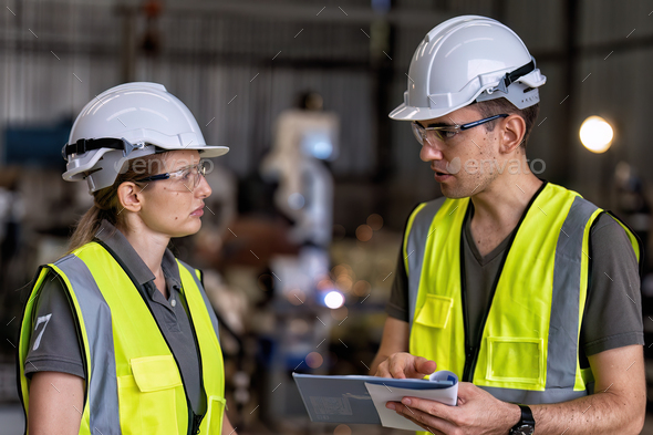 In robotic maintenance shop engineer busy commissioning and operate ...