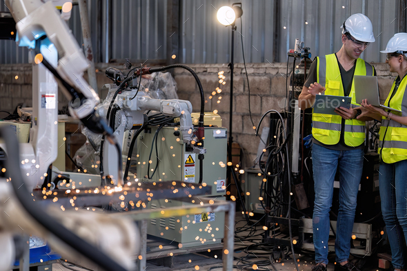 In robotic maintenance shop engineer busy commissioning and operate ...