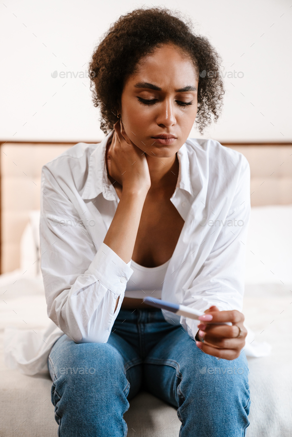 Young Black Woman Being Upset While Holding Pregnancy Test At Home