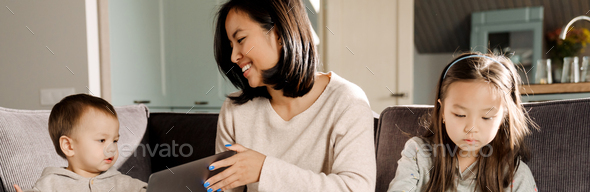 Young asian woman smiling while spending time with her children Stock ...