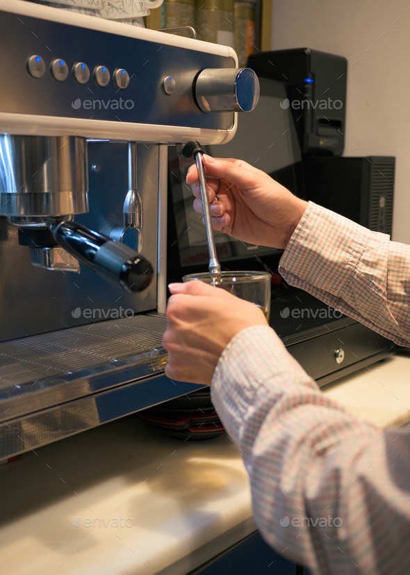 Close-up of a waiter at a coffee machine Stock Photo by CristianBlazMar