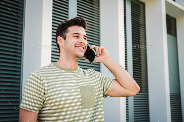Awesome happy teenager male calling a friend using an smart phone ...