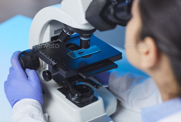 Investigating sample via microscope Stock Photo by Media_photos | PhotoDune