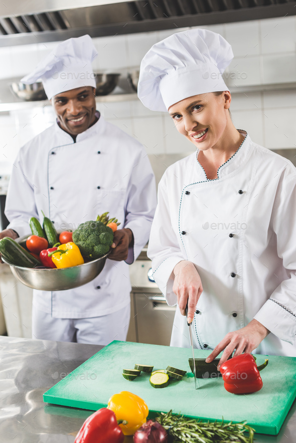 smiling multicultural chefs cooking at restaurant kitchen Stock Photo ...