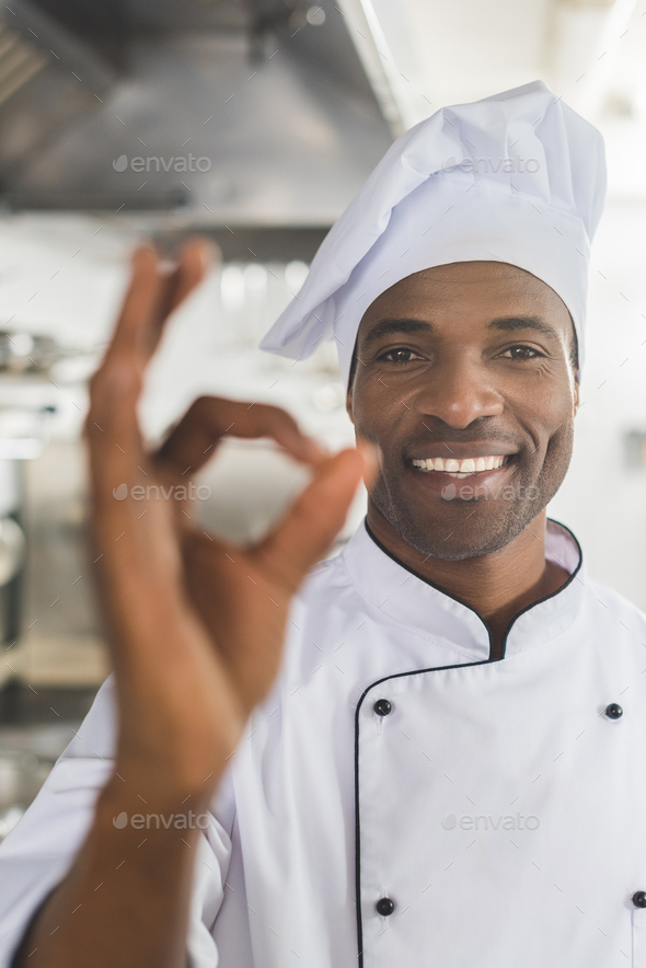 smiling african american chef showing okay gesture at restaurant ...