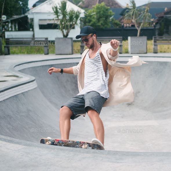 handsome young man skating at skatepark Stock Photo by LightFieldStudios